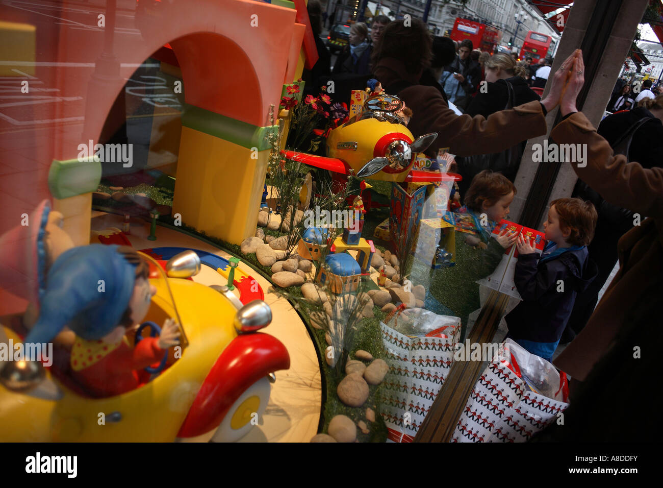 A young child peers into the window of famous London toy shop Hamleys ...