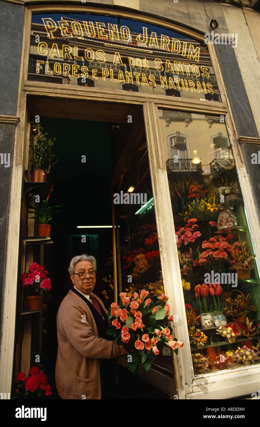 A Portuguese gentleman florist shows a bunch of his pink roses on sale ...