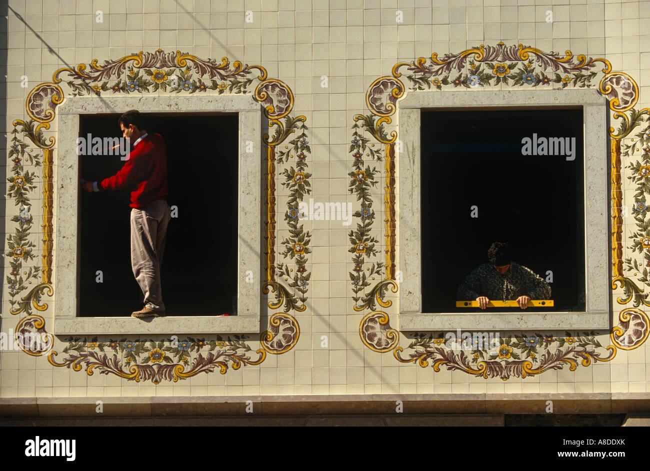 Portuguese workmen finish new window frames that have kept the ornate ...