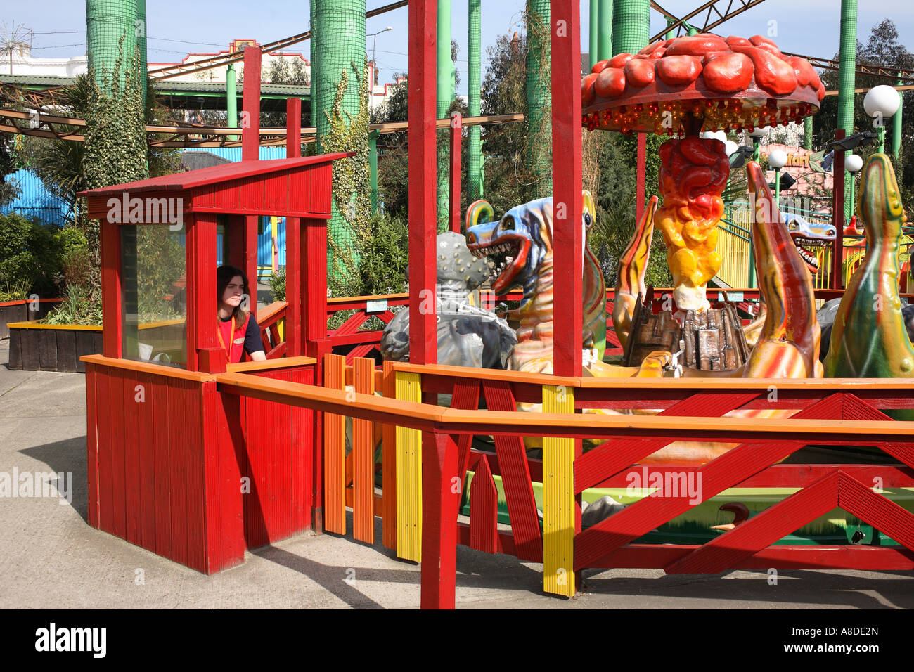 Fairground ride worker sits in a confined red kiosk at Treasure Island ...