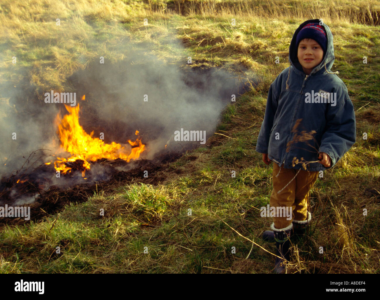 Boy playing with fire Stock Photo - Alamy