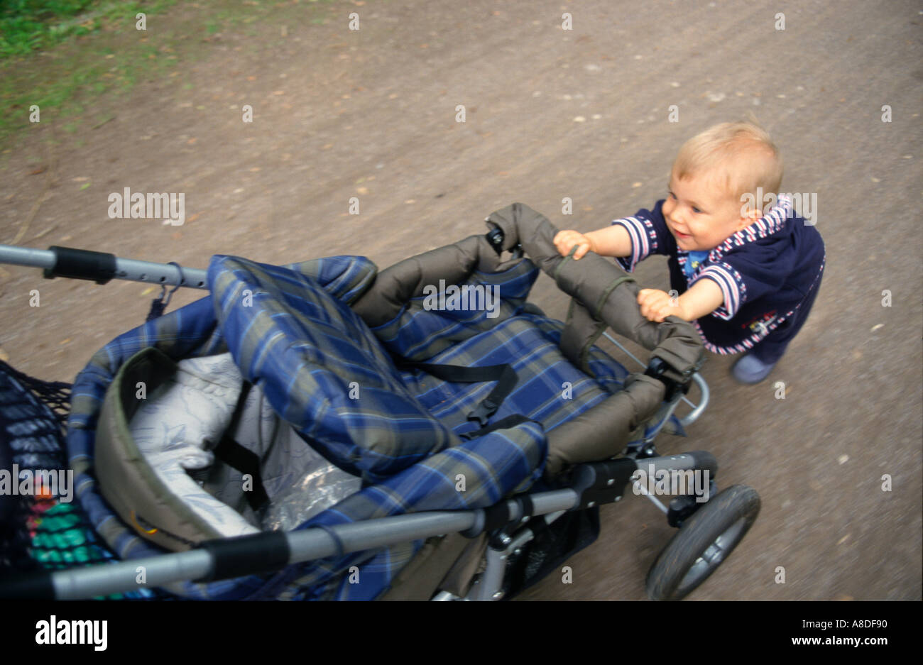 Pushing his buggy Stock Photo - Alamy