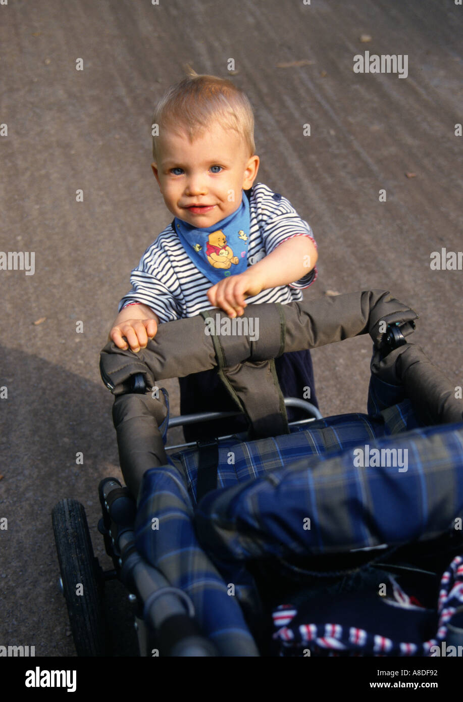 Pushing his buggy Stock Photo - Alamy