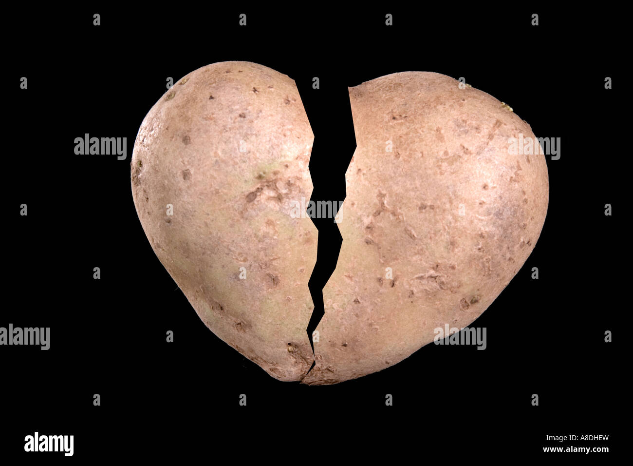 Broken heart shaped potato isolated on a black background Stock Photo ...