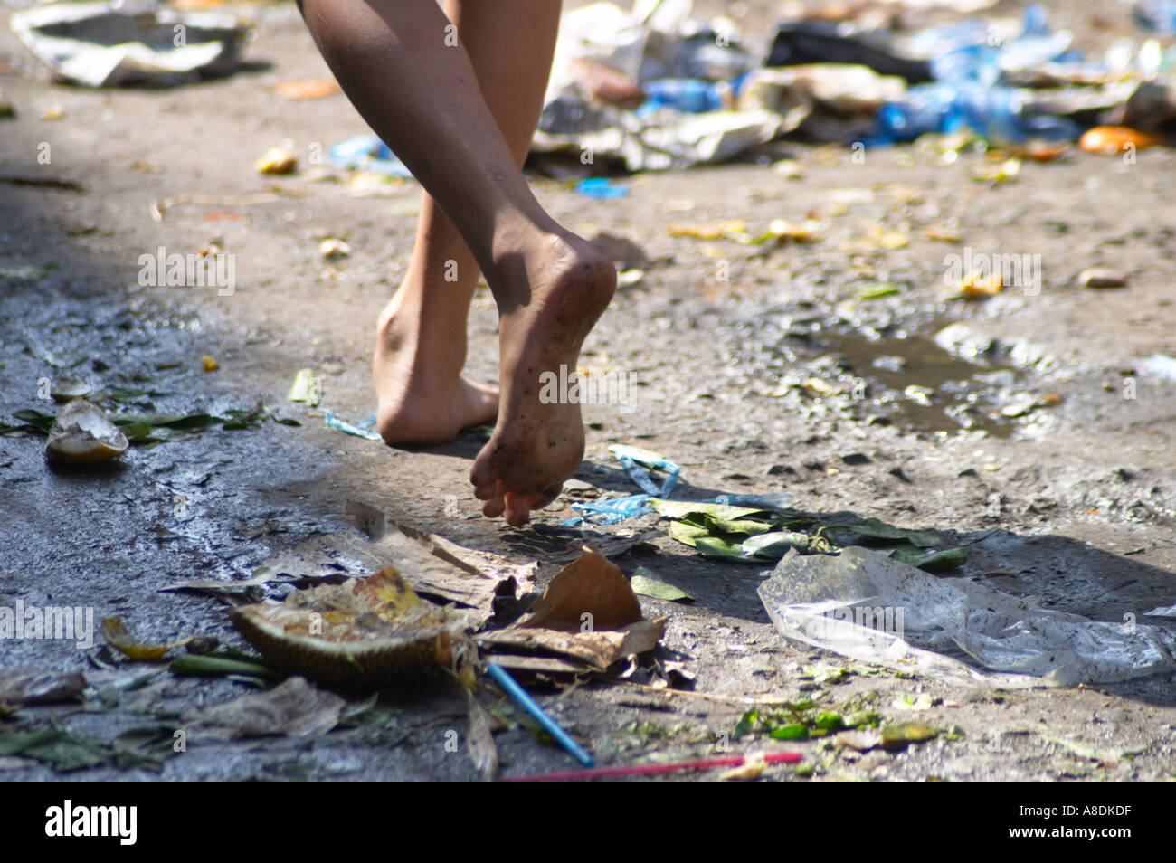 boys feets bare foot on a dirty street in a poor market area of central ...
