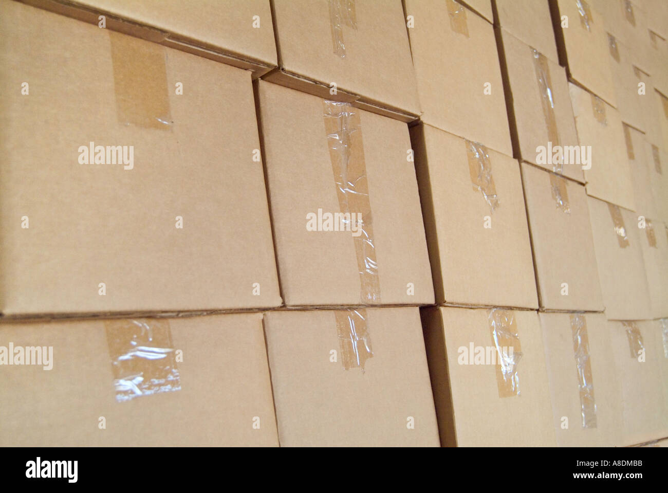 cardboard boxes stacked in a warehouse Stock Photo - Alamy