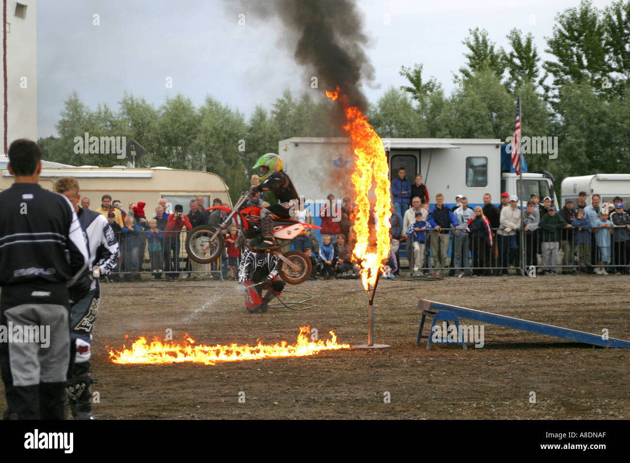 Stunt kid on a motorcycle jumping through fire Stock Photo - Alamy