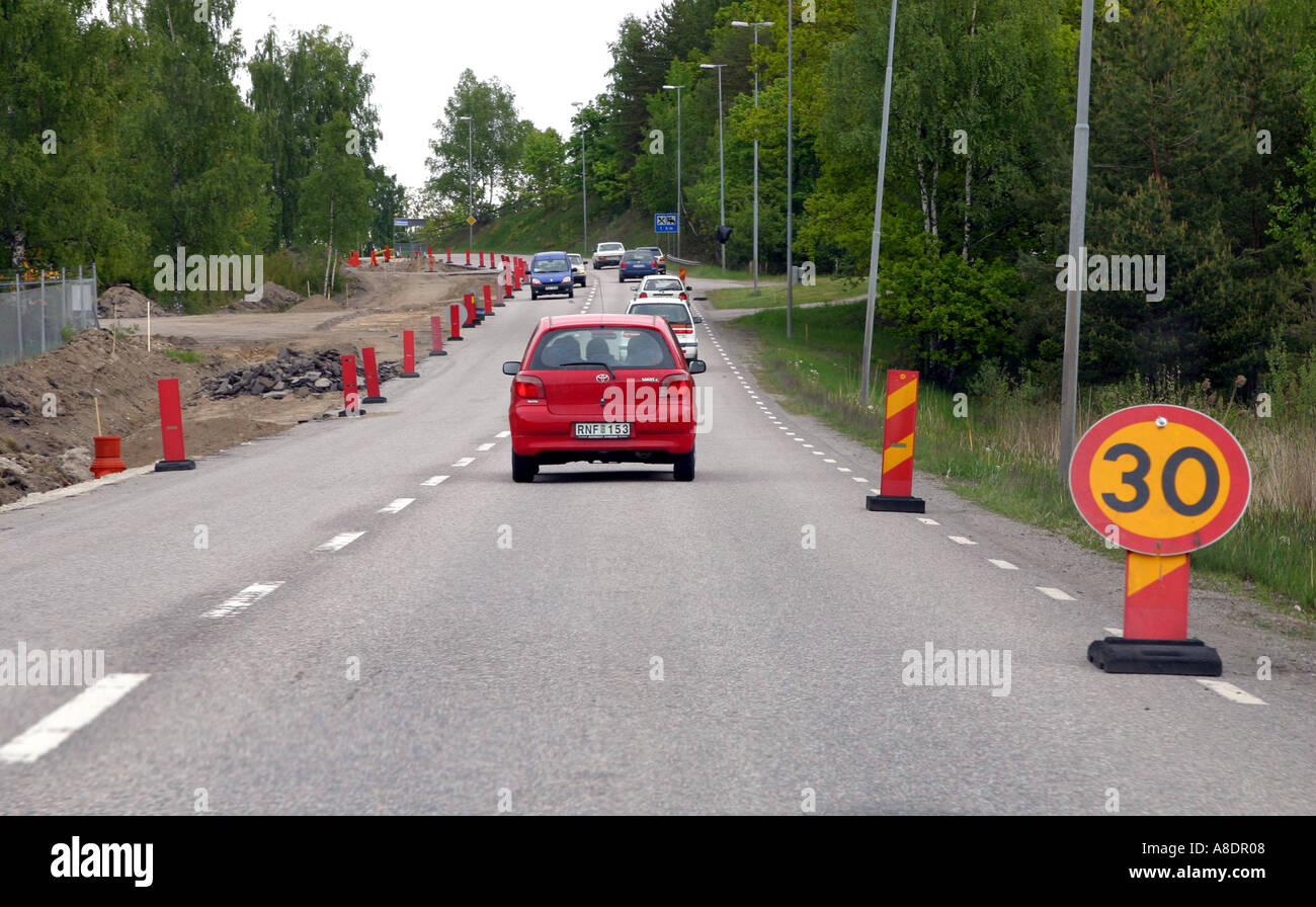 Slow traffic, 30 km/h, while working on the road Stock Photo - Alamy