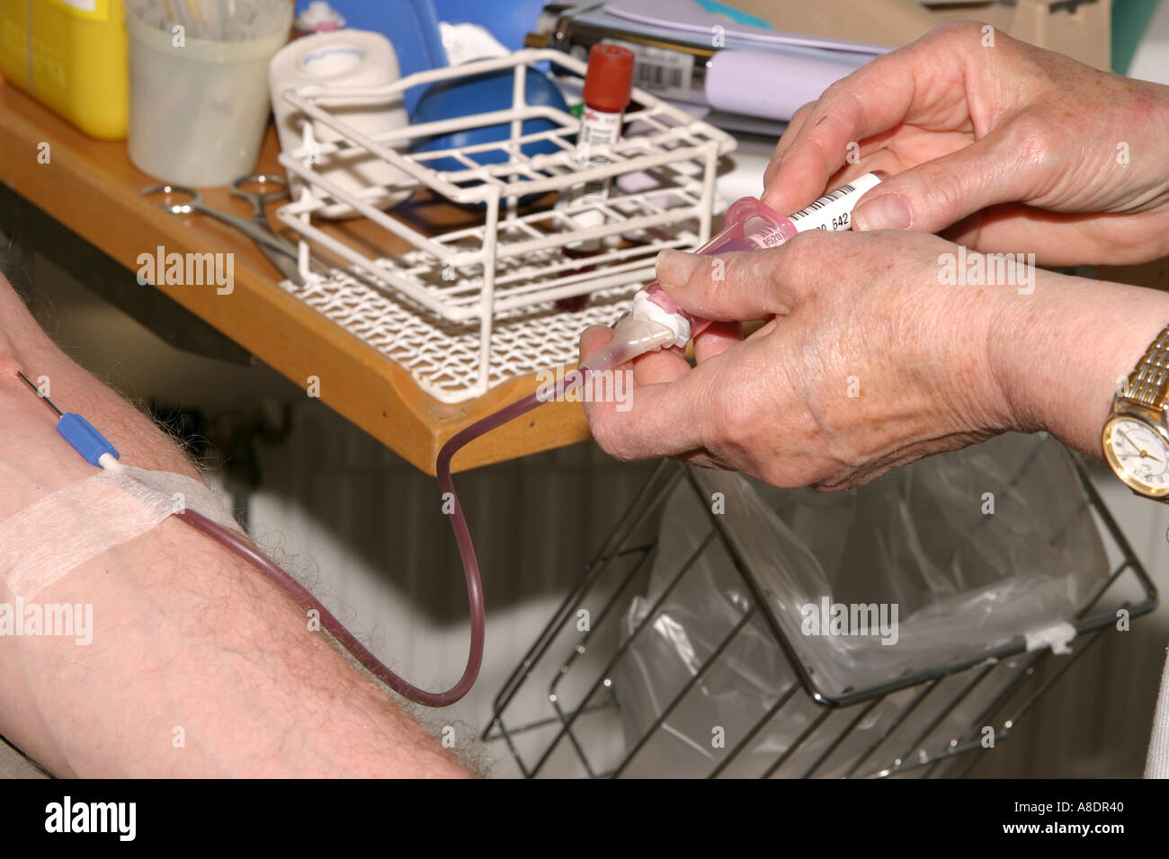 Taking test tubes of blood from a blood donor after giving blood Stock ...