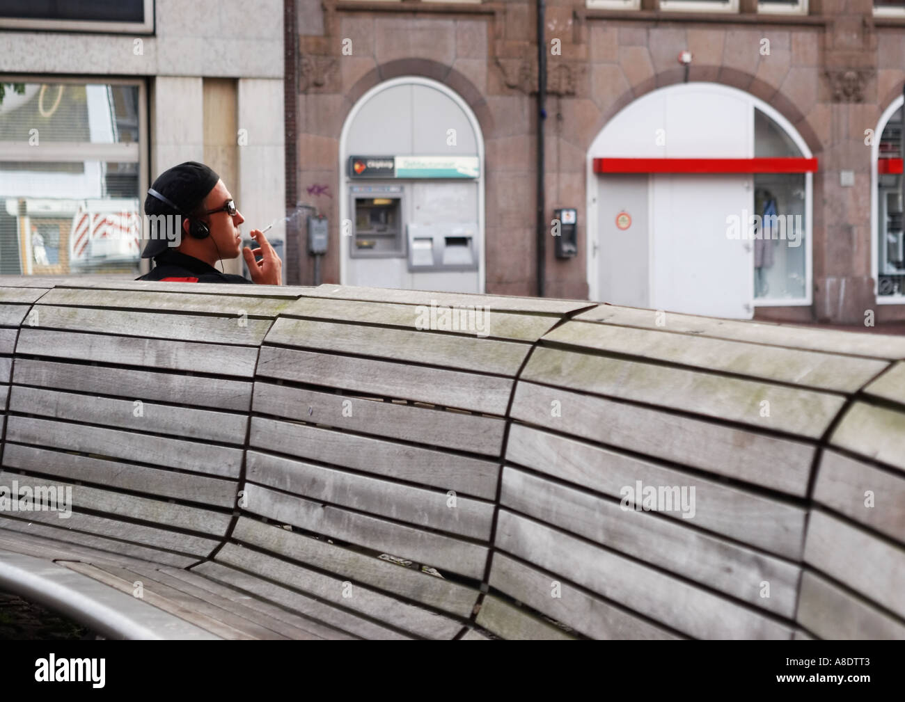 Man Smoking Cigarette Sitting On Bench Stock Photo - Alamy