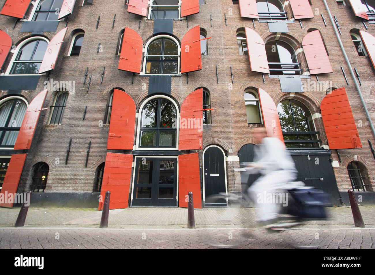 Cyclist Passing Shuttered Building Stock Photo - Alamy