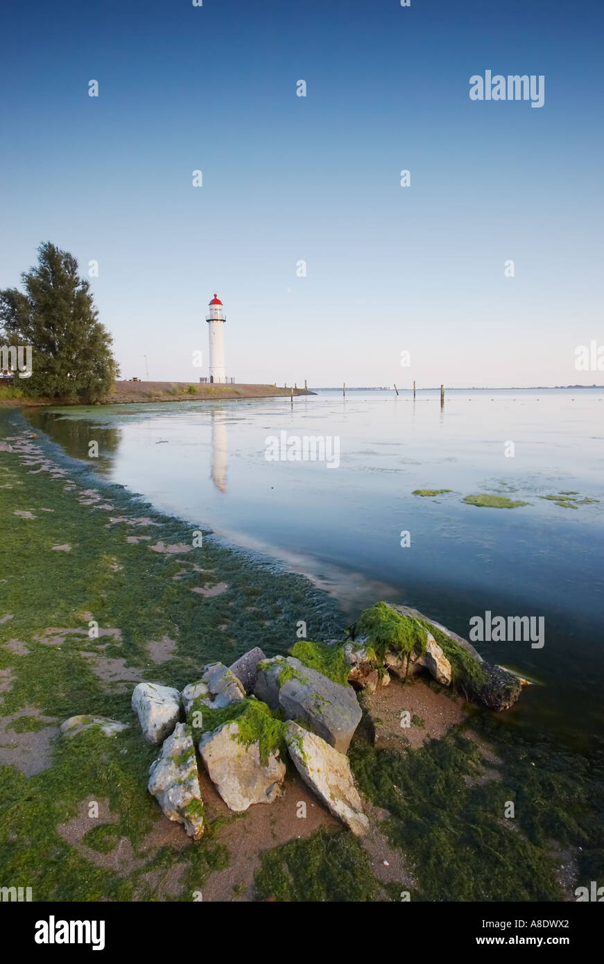 Reflection Of Lighthouse In Sea Stock Photo - Alamy