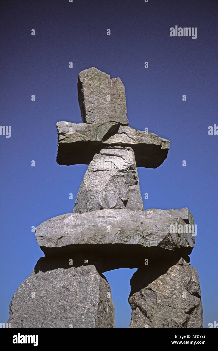 Traditional Inuit stone Inukshuk against a deep blue sky English Bay ...