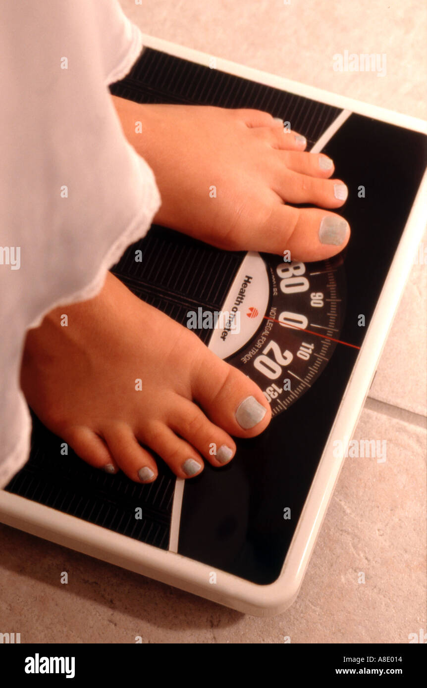 Girl weighing herself scale hi-res stock photography and images - Alamy