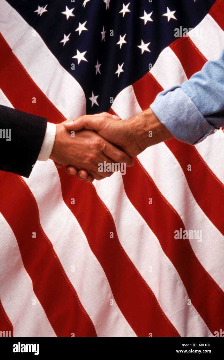 Businessmen shaking hands in front of flag Stock Photo - Alamy