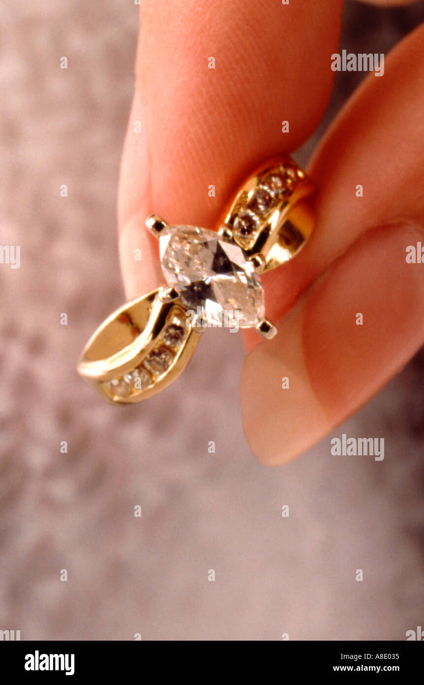 Hand holding diamond ring Stock Photo - Alamy