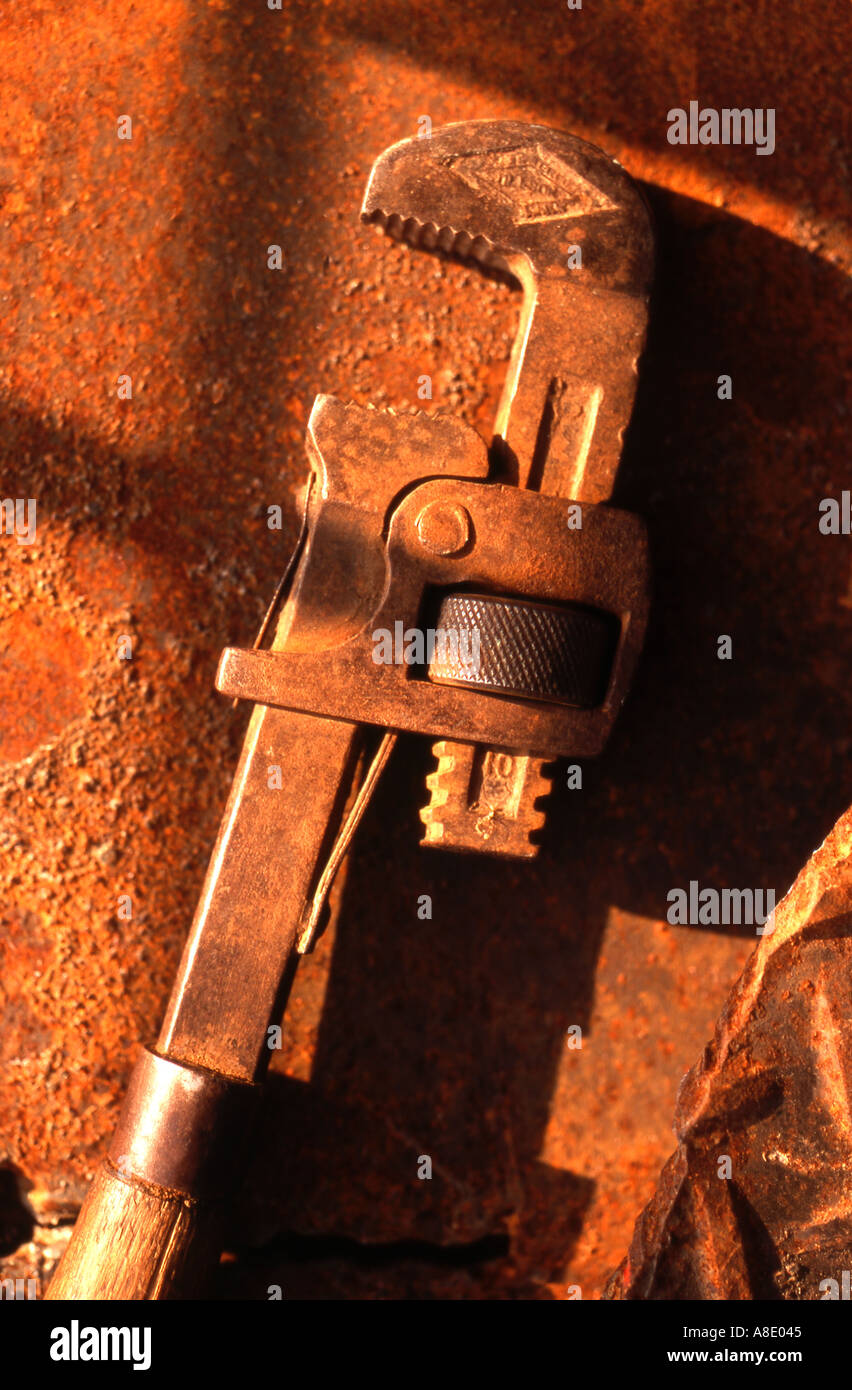 Pipe wrench lying on metal background Stock Photo - Alamy