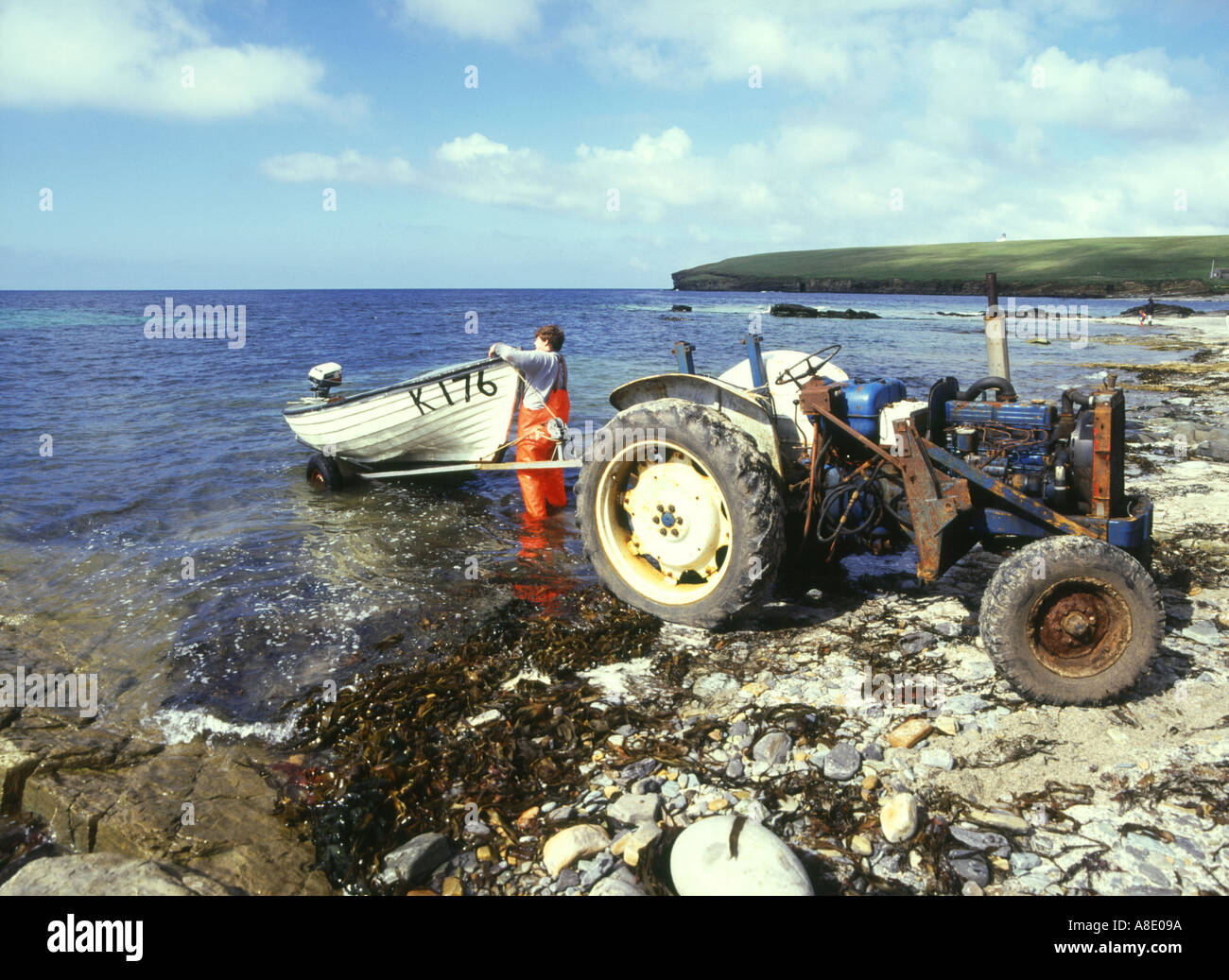 dh Birsay Bay BIRSAY ORKNEY Fisherman with tractor launching boat ...