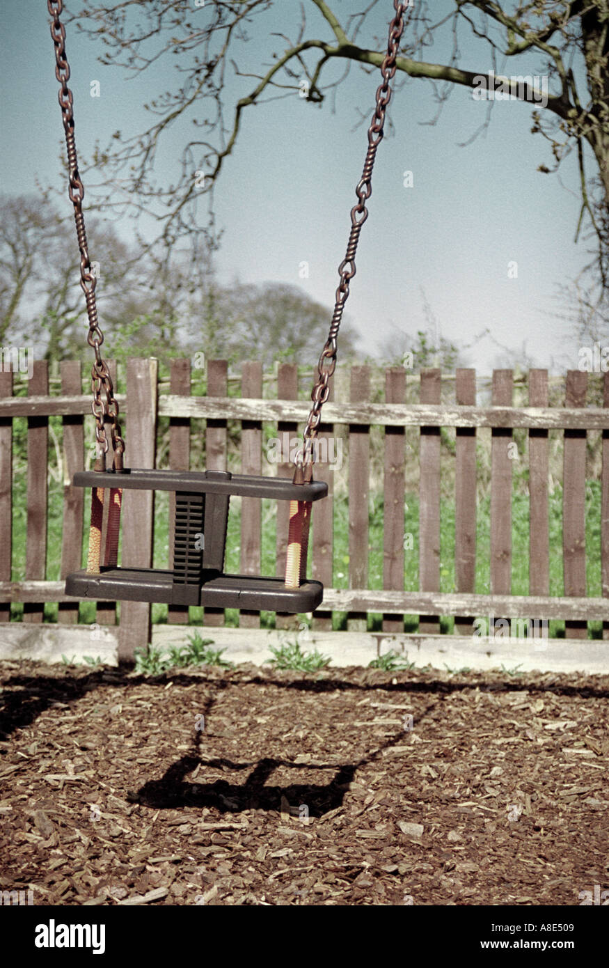 Childrens swing in playground Stock Photo - Alamy