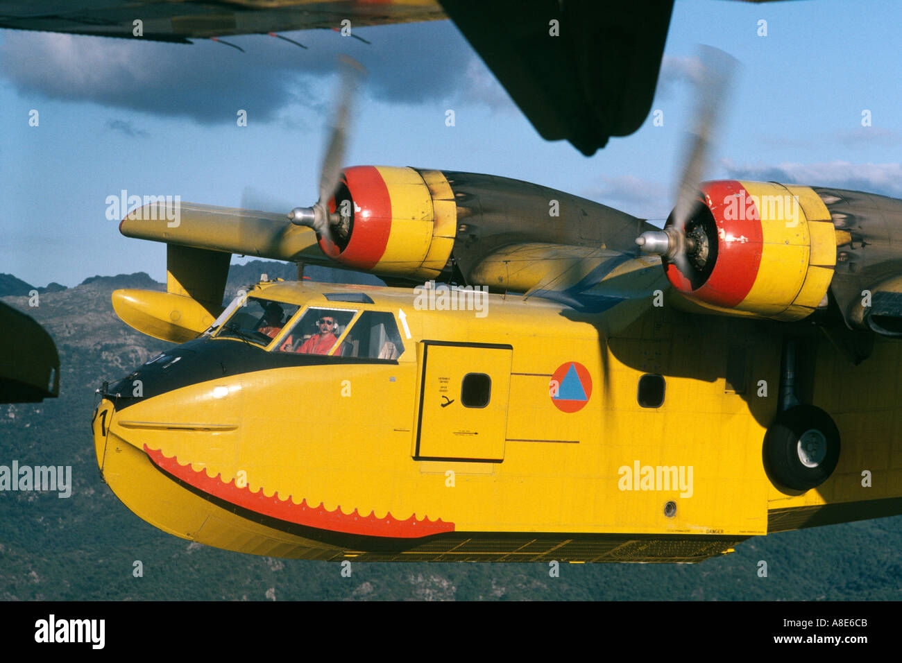 Aerial view of a Canadair firefighting water bomber airplane in flight ...