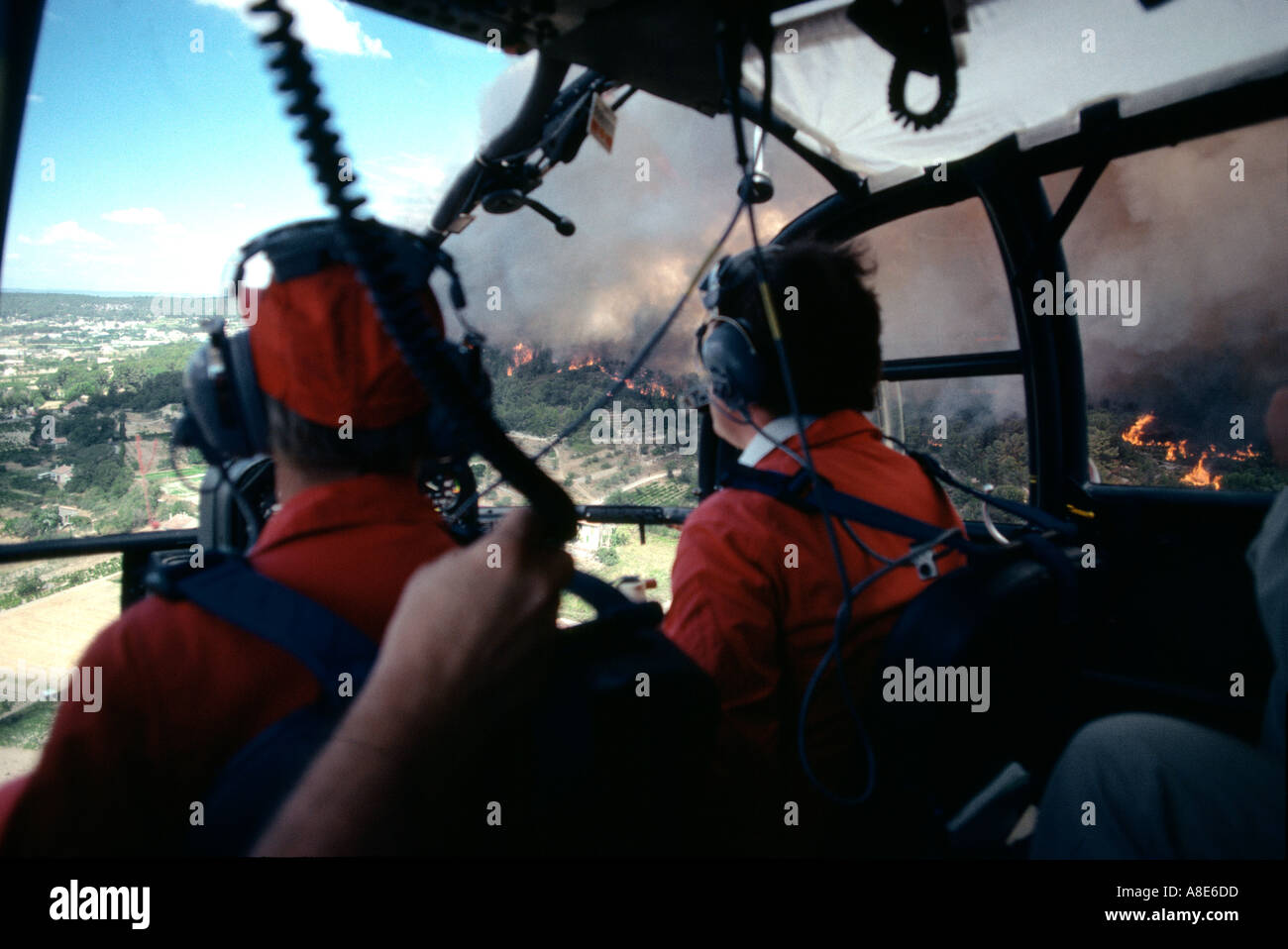 Pilots inside cockpit of firefighters Alouette III command helicopter ...
