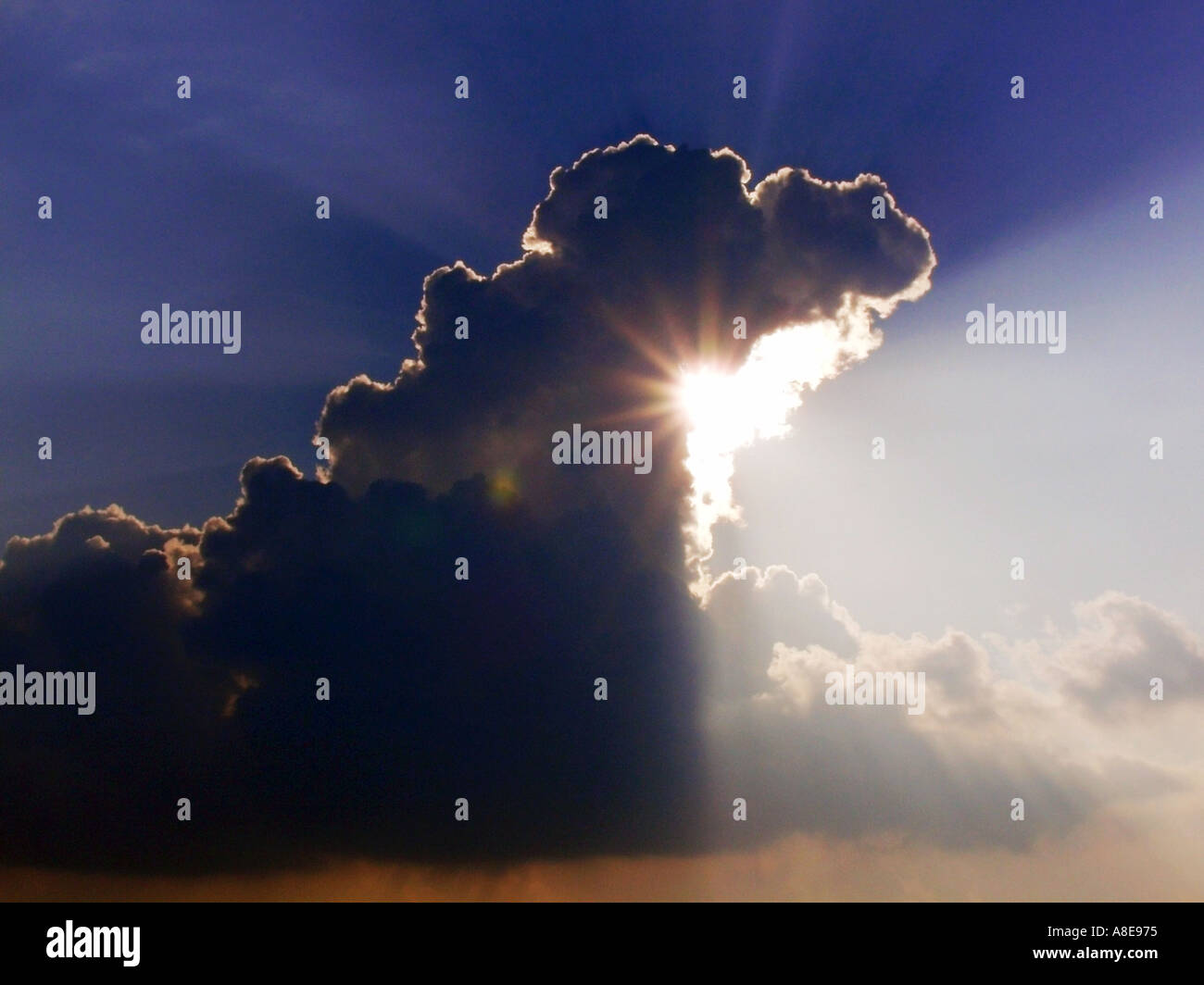 Sun behind clouds Stock Photo - Alamy