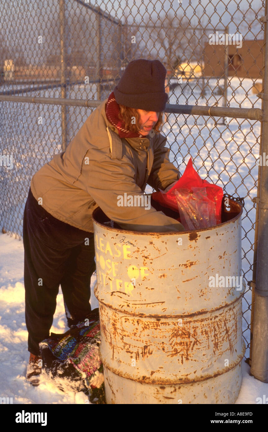 Homeless woman age 50 digging in the trash. St Paul Minnesota USA Stock ...