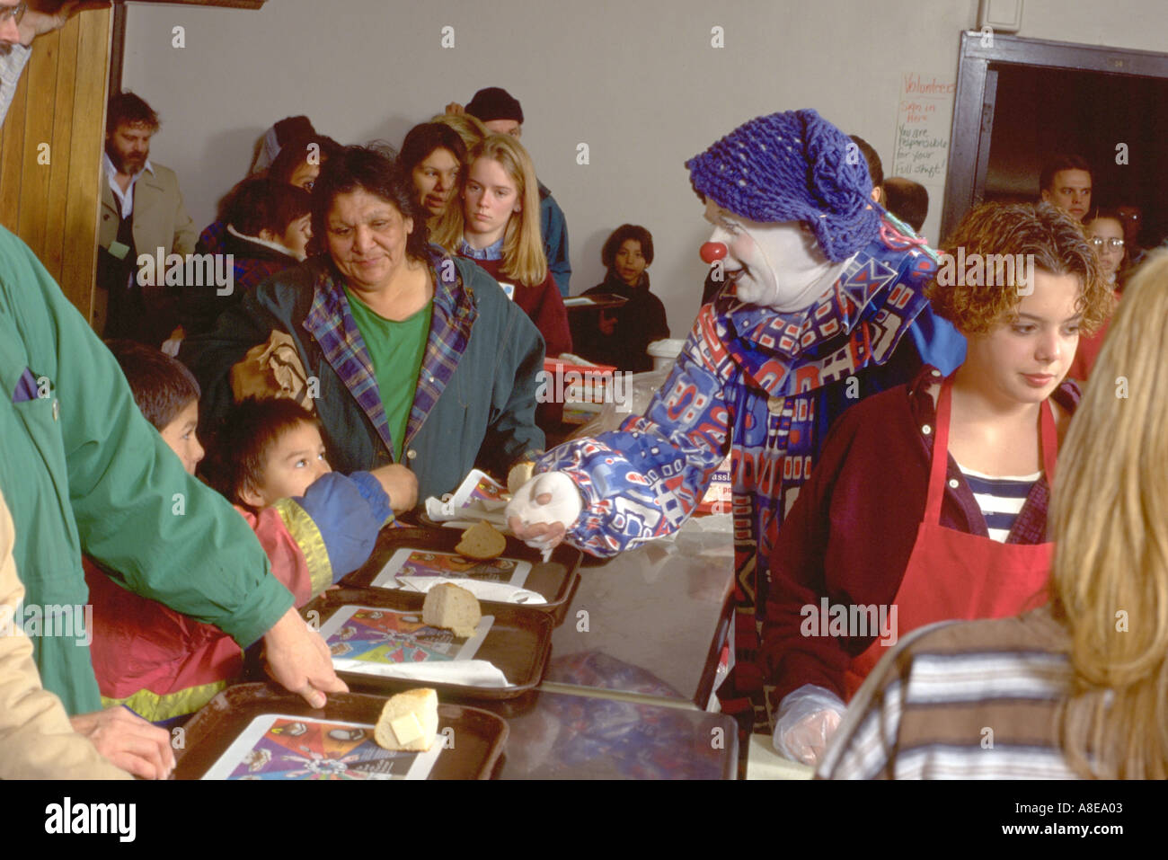 Clown serving Christmas dinner at church soup kitchen. Minneapolis ...