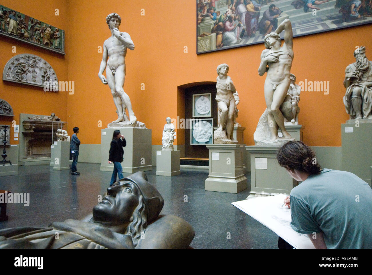 An artist drawing in a gallery of statues at the Victoria and Albert ...