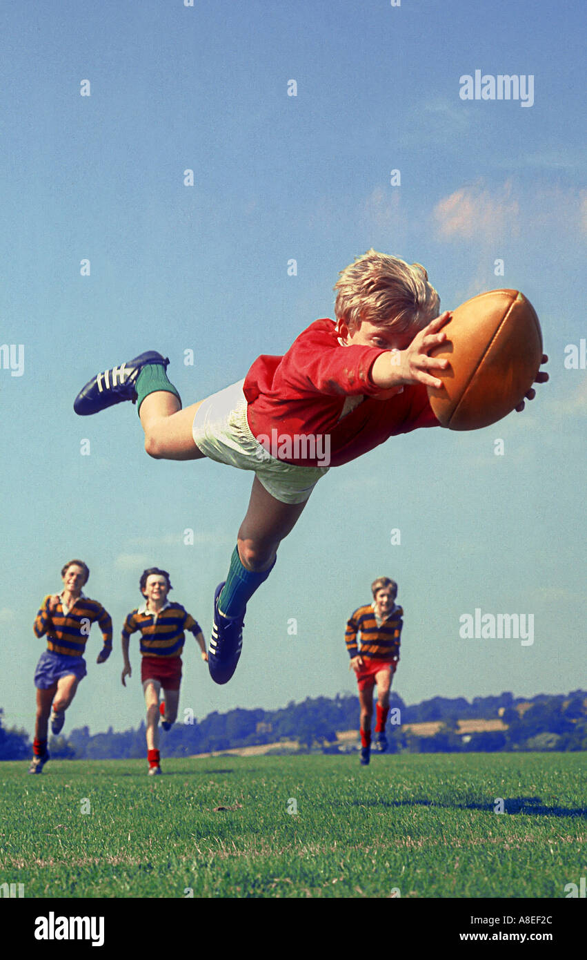 Young rugby player scoring a try Stock Photo - Alamy