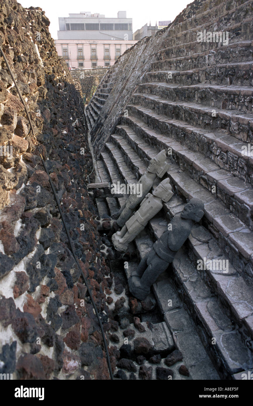Aztec statues rest on the steps of the ruins of a pyramid in the Templo ...