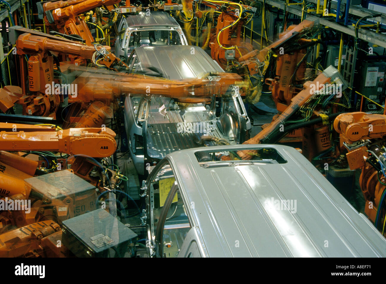 Robots welding SUV bodies on an assembly line at the Chevrolet Suburban ...