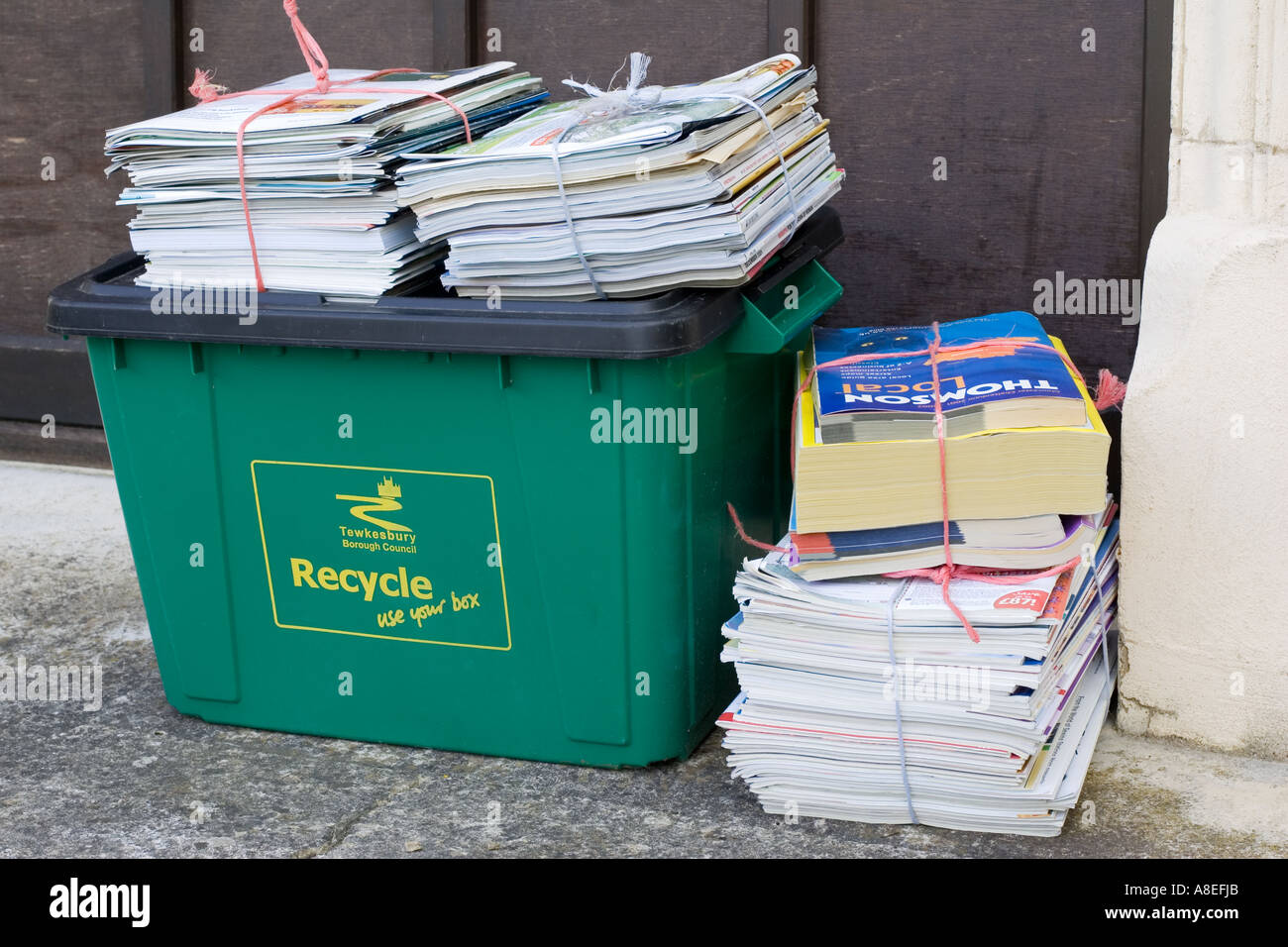 Bundles of magazines and newspapers neatly tied and left for recycling ...