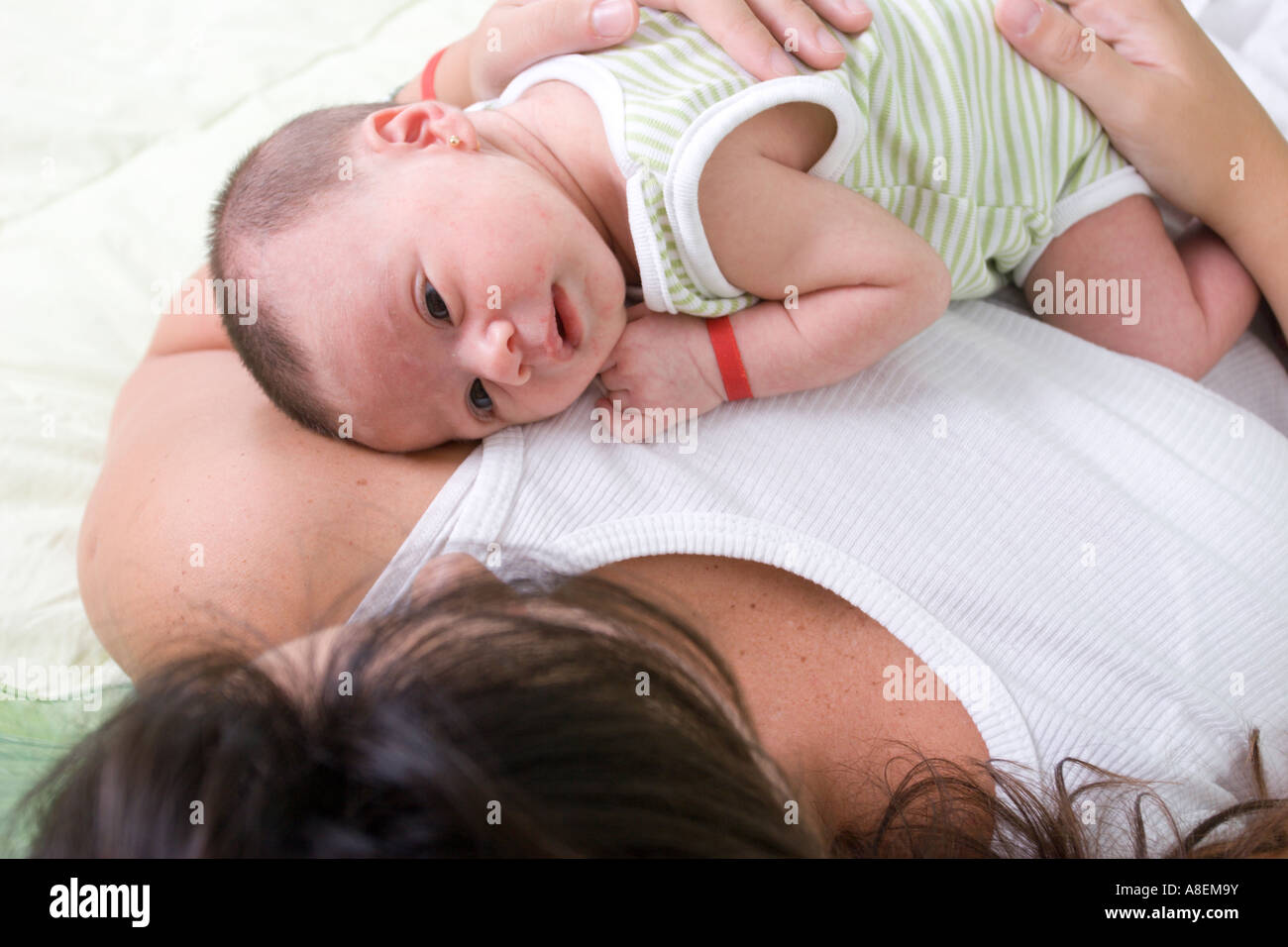 Young baby resting on her mother Stock Photo - Alamy