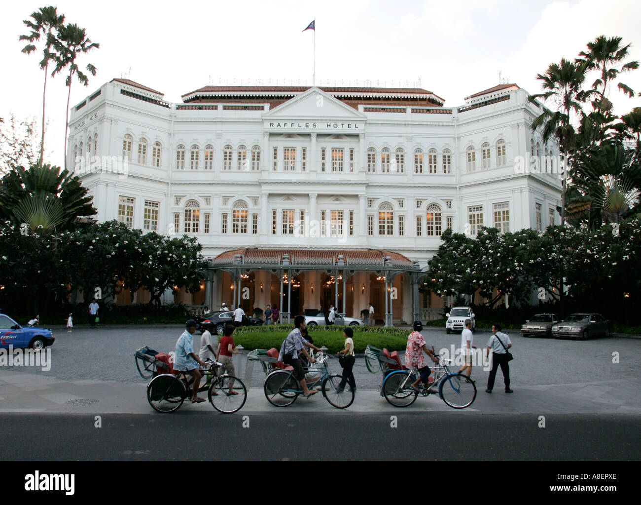 Rickshaw driver dropping off guests in front of Raffles Hotel in ...