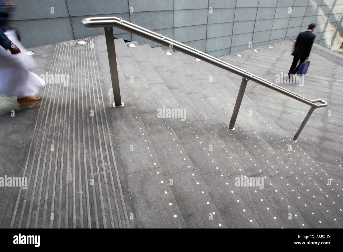 Business man walking accross concourse Stock Photo - Alamy