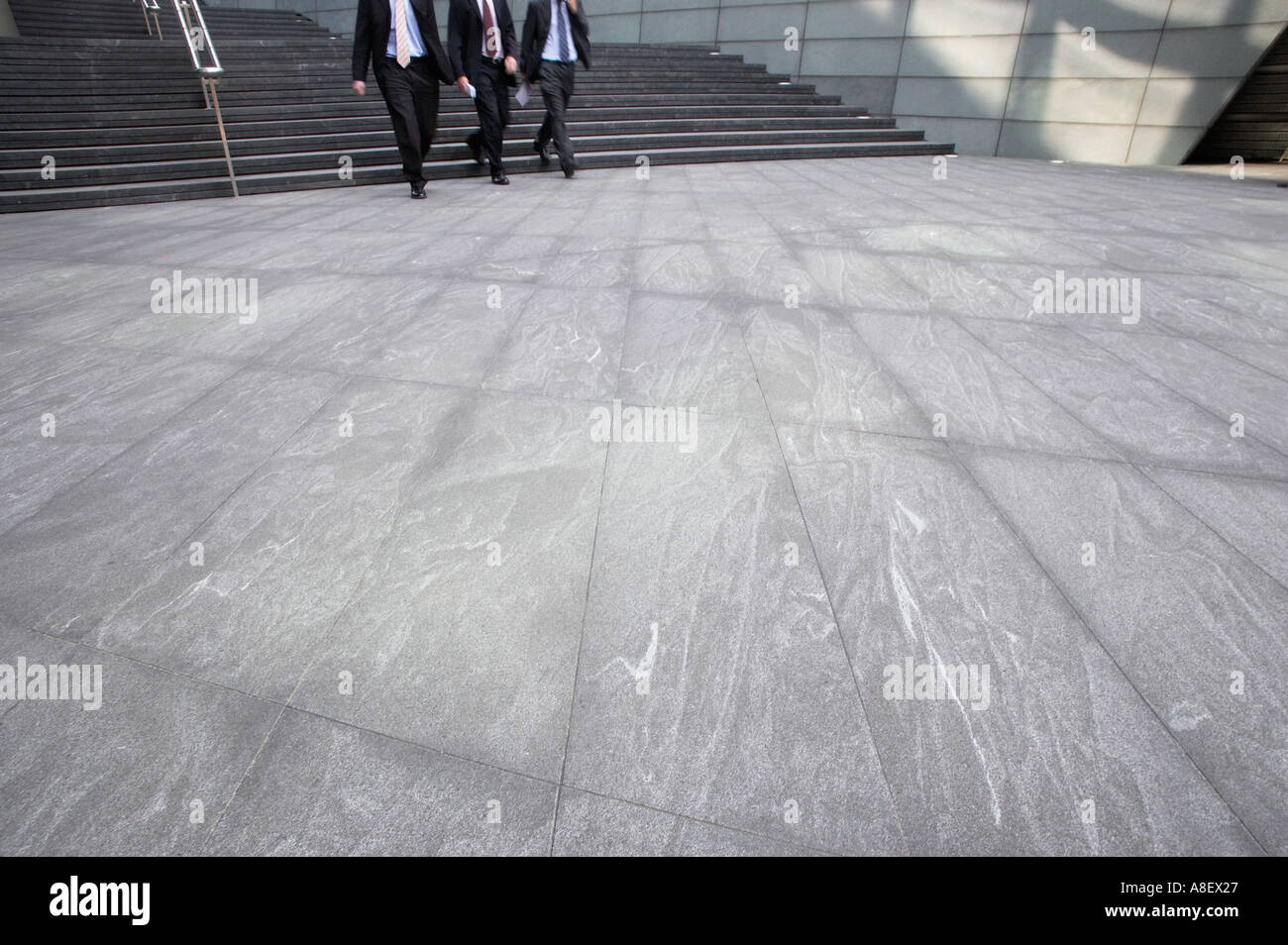 Business men walking accross concourse Stock Photo - Alamy