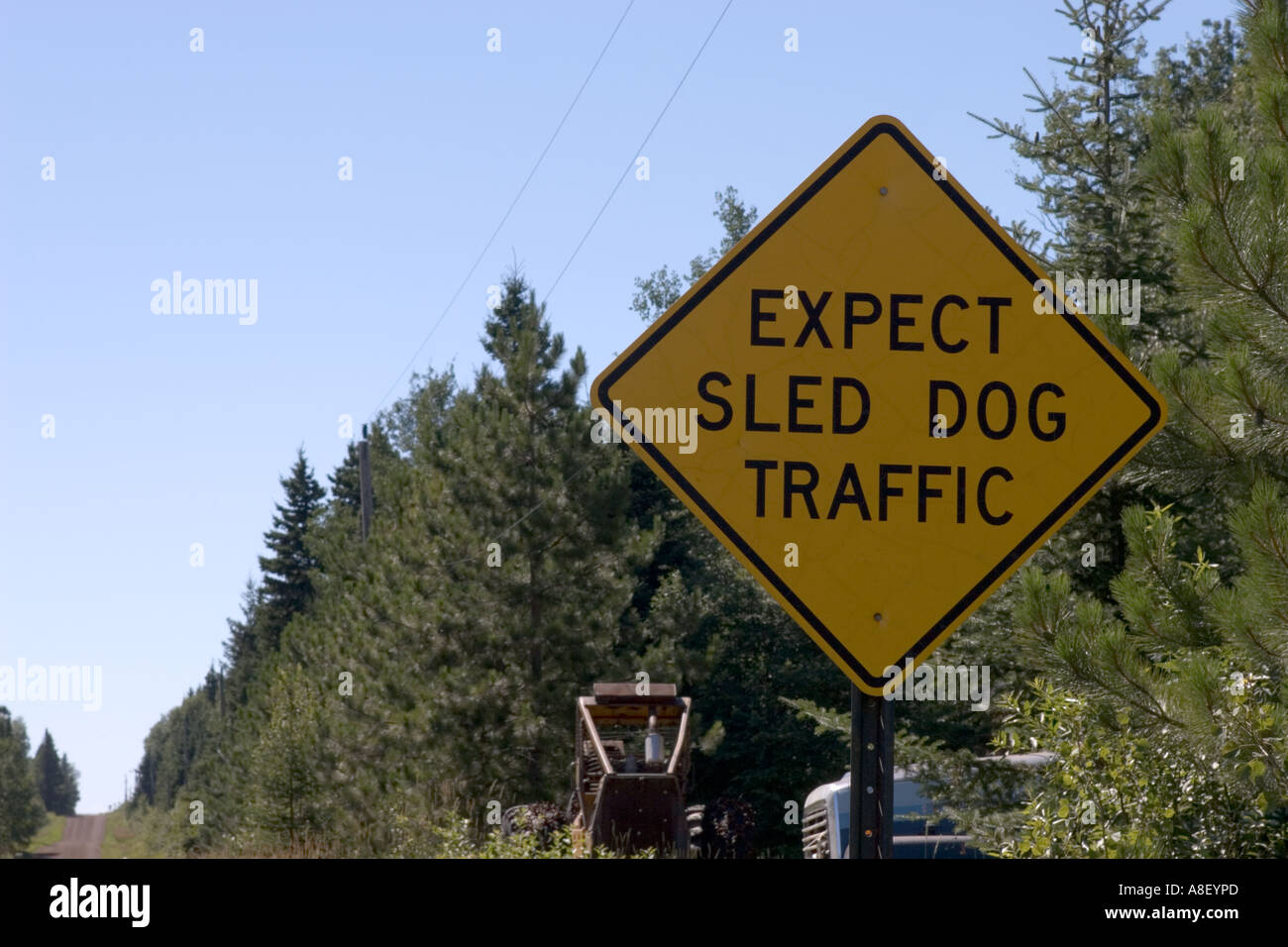 Warning sign for a dogsled crossing Stock Photo - Alamy