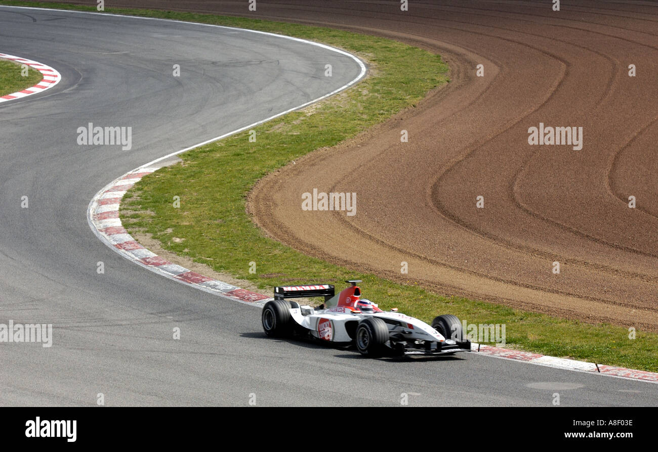 Formula 1 racing car on a track with curves Stock Photo - Alamy