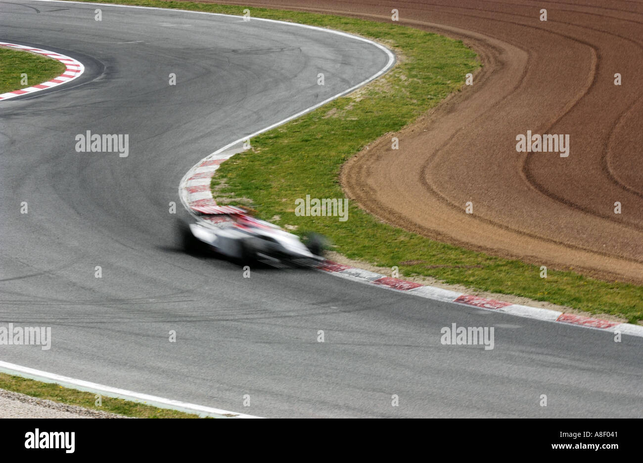 Formula 1 racing car on a track with curves Stock Photo - Alamy
