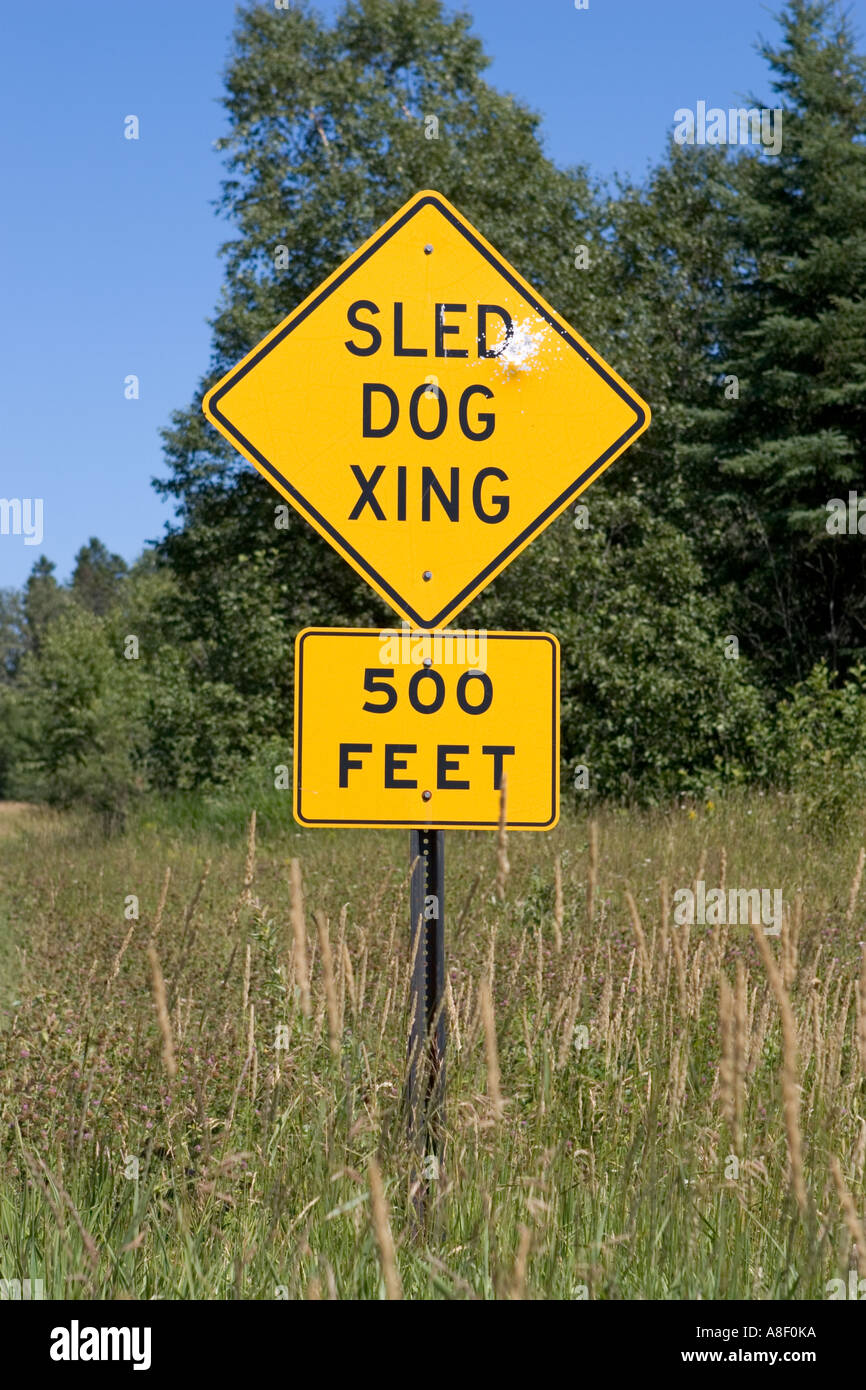 Warning sign for a dogsled crossing Stock Photo - Alamy