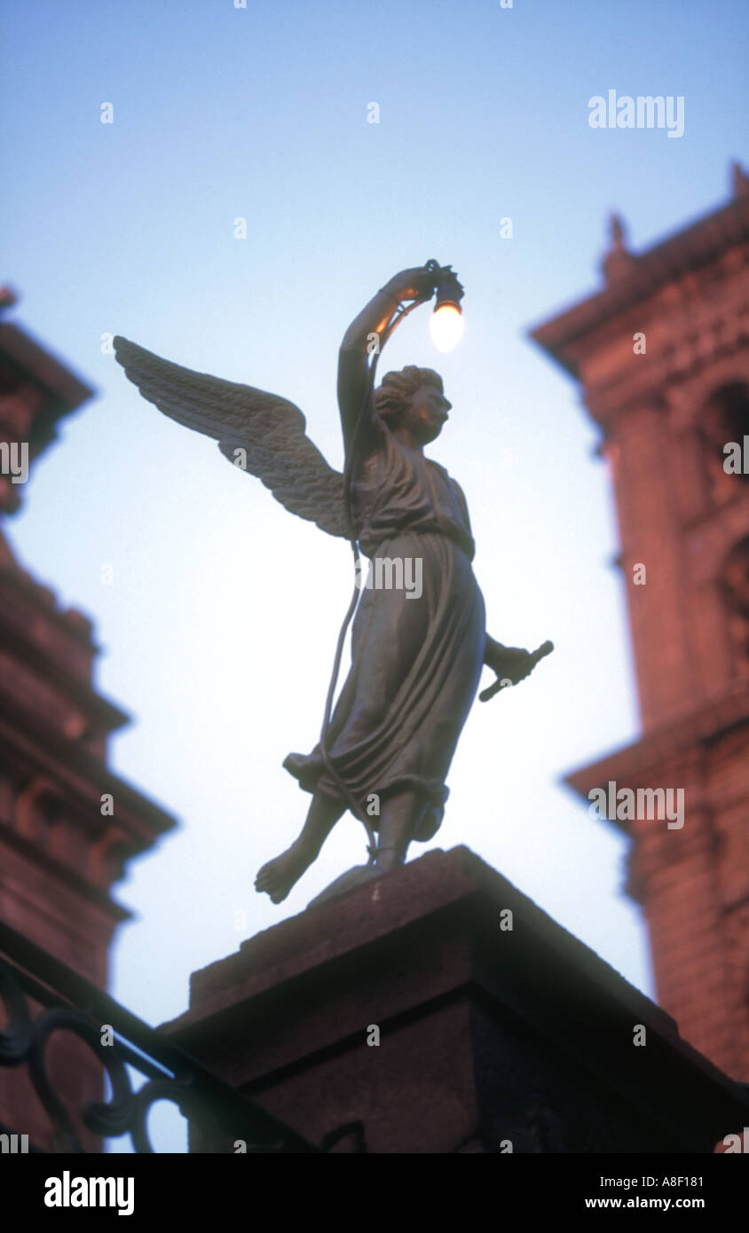 Cast iron lamppost like an angel by Puebla Cathedral in Mexico at dawn ...