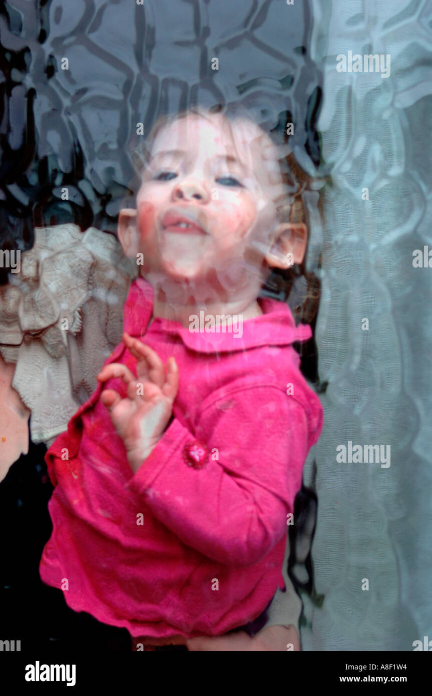 Little Girl Behind Glass Door Stock Photo - Alamy