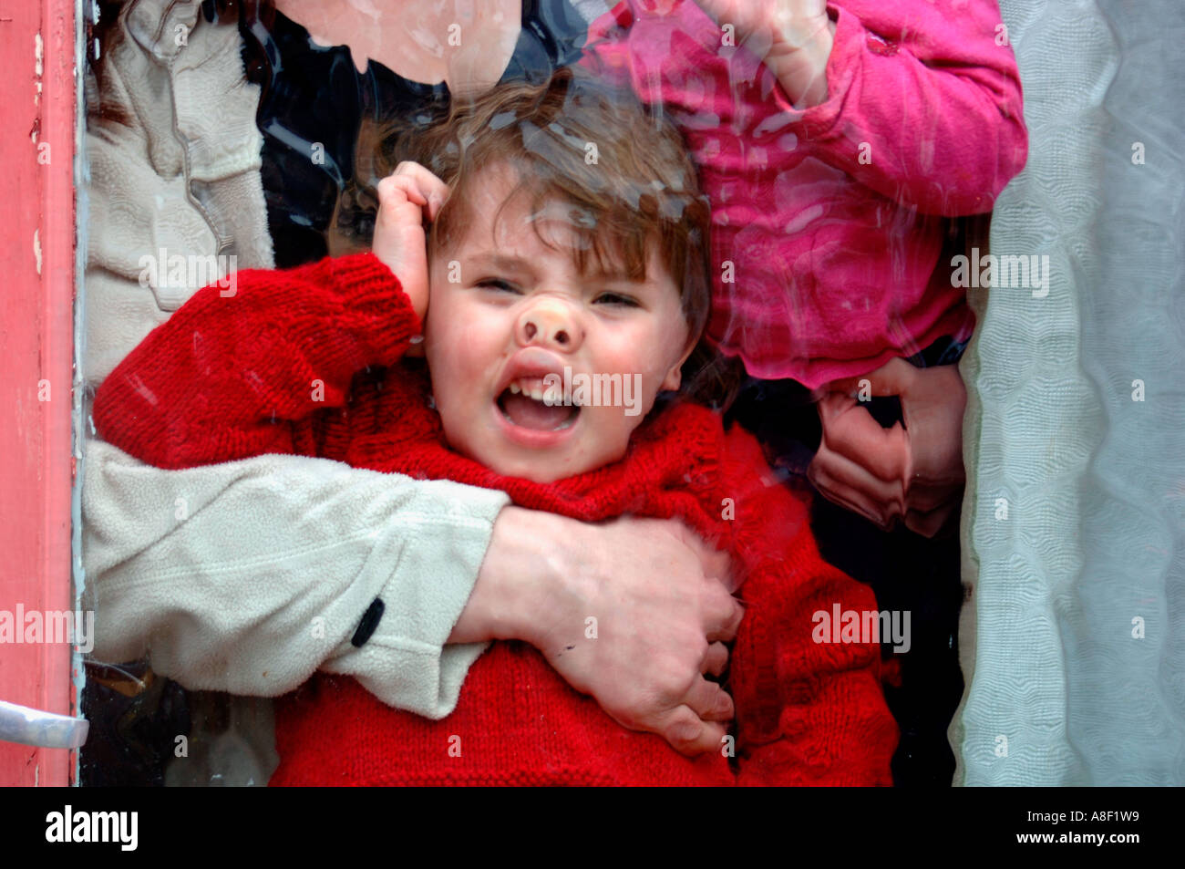 Little Girl Behind Glass Door Stock Photo - Alamy