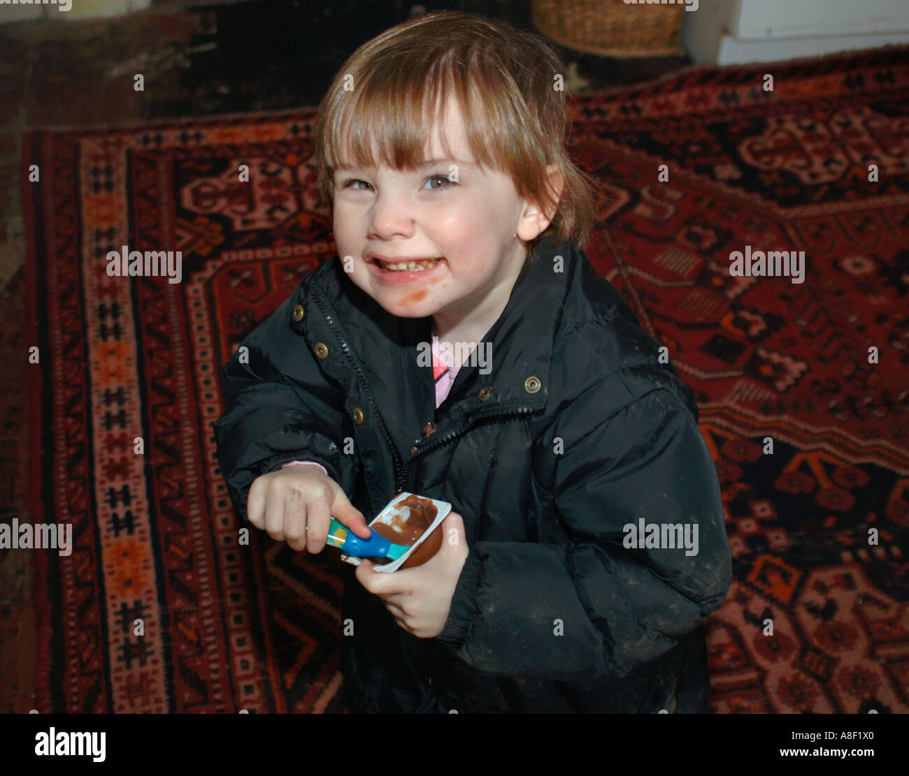 Little Girl Eating A Chocolate Pudding Stock Photo - Alamy