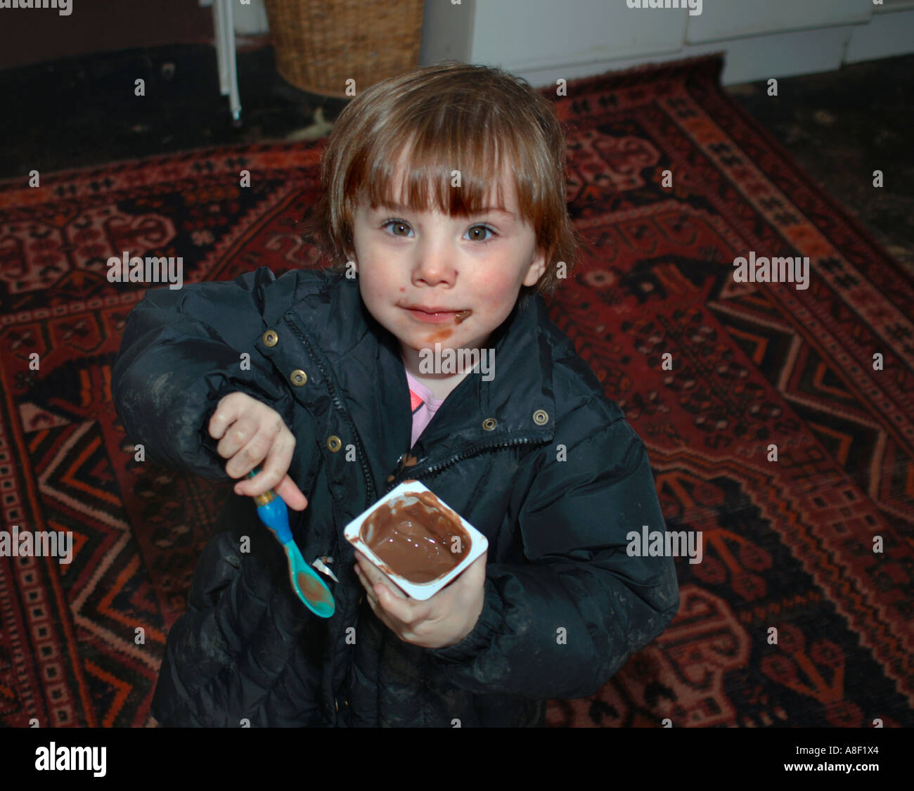Little Girl Eating A Chocolate Pudding Stock Photo - Alamy