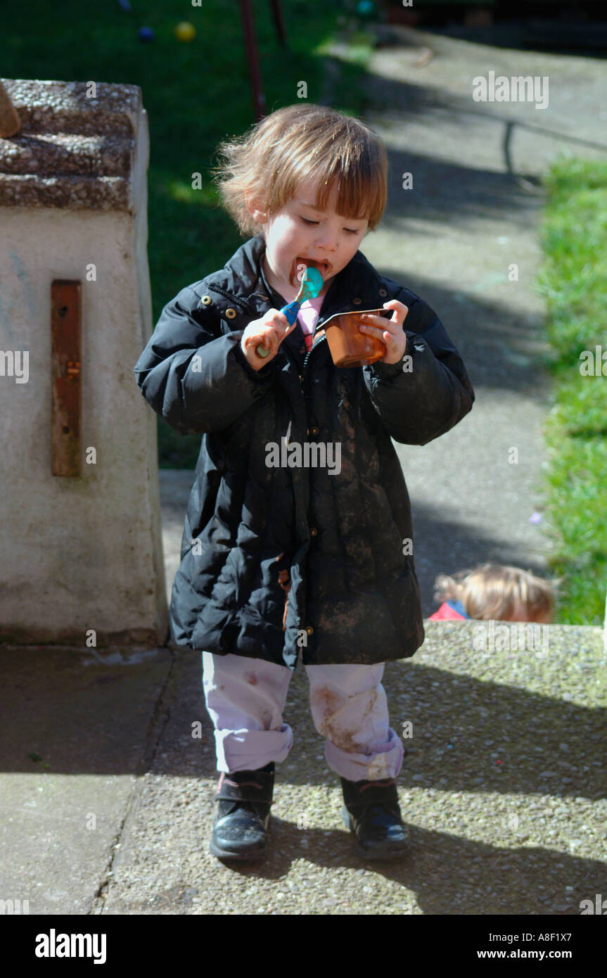 Little Girl Eating A Chocolate Pudding Stock Photo - Alamy