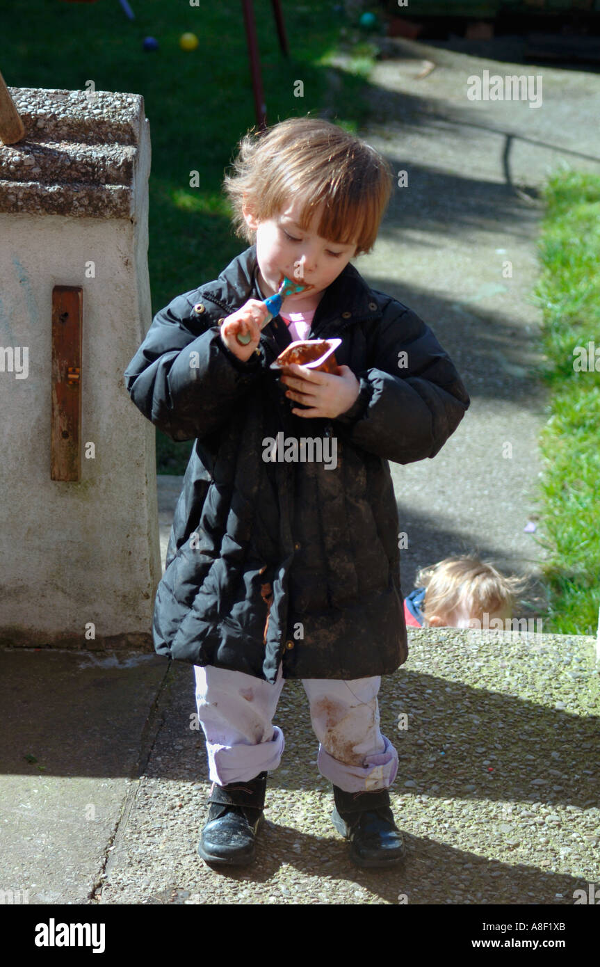 Little Girl Eating A Chocolate Pudding Stock Photo - Alamy