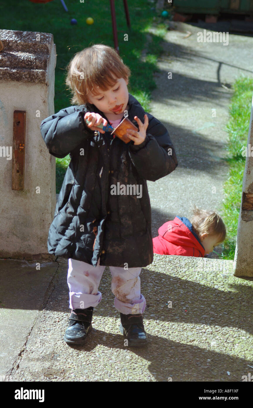 Little Girl Eating A Chocolate Pudding Stock Photo - Alamy
