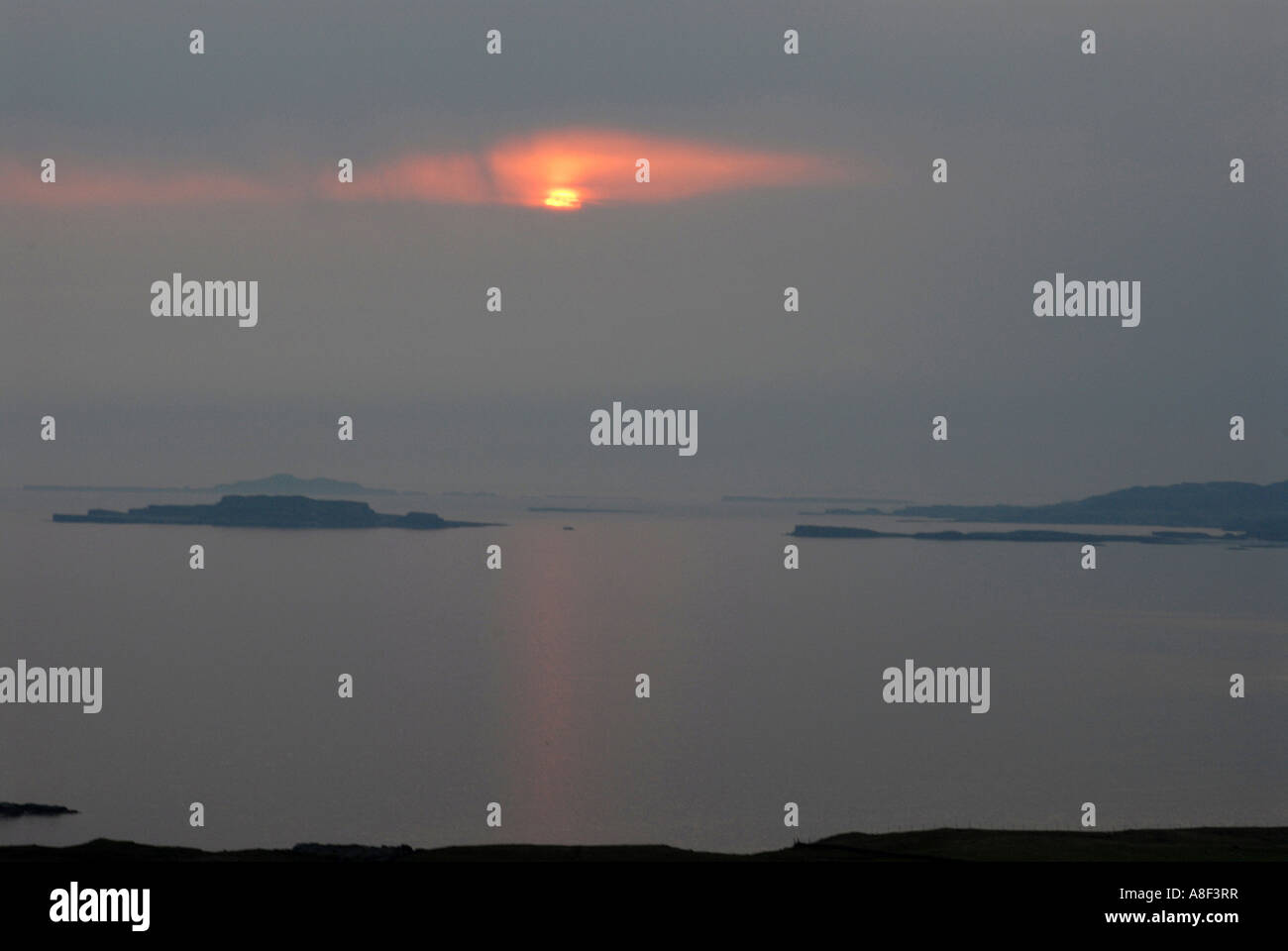 The fading sunset over the Inner Hebrides islands from the Isle of Mull ...